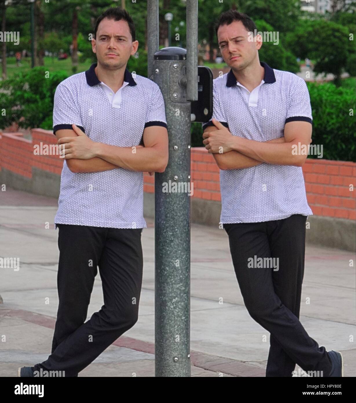Man Posing As Twin Brothers Stock Photo - Alamy