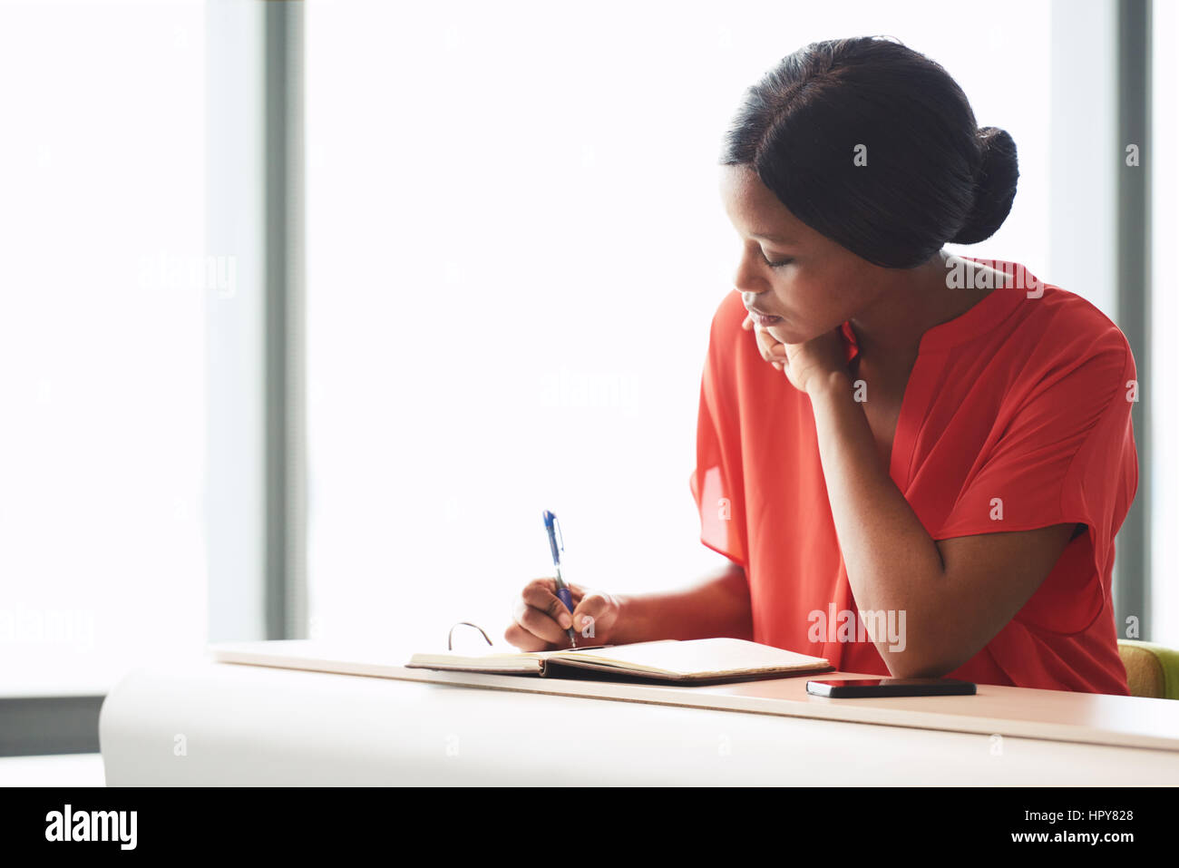 Woman writing diary behind window hi-res stock photography and images ...
