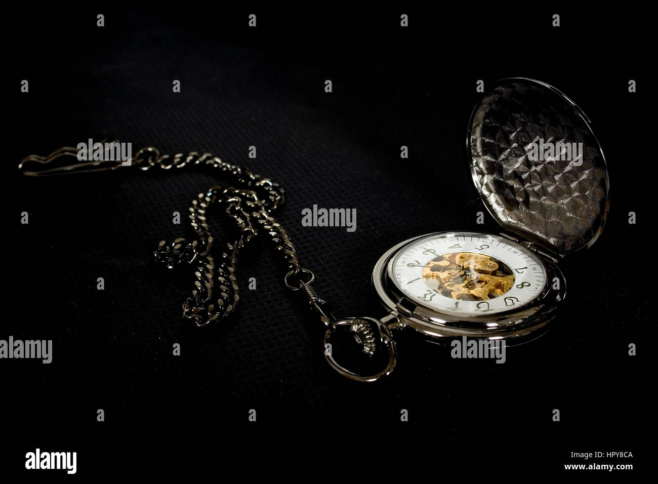 aged clock on black background Stock Photo - Alamy
