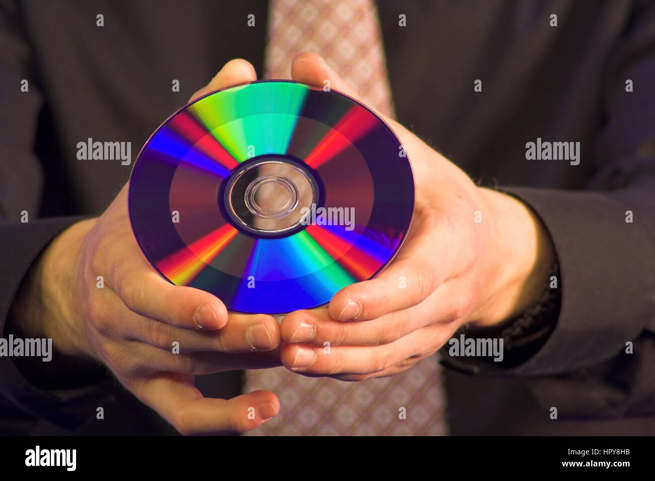 business hands holding a CD Stock Photo - Alamy