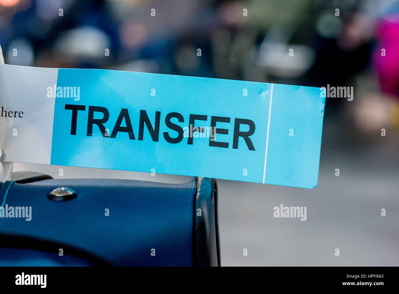 Close-up photograph of luggage with transfer label at airport with ...
