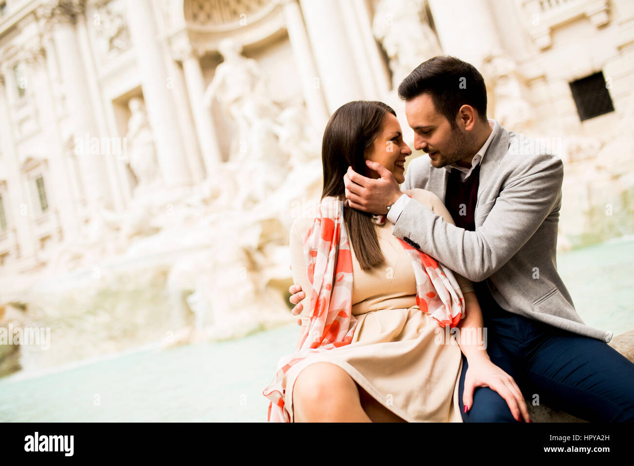 Tourist couple on travel by Trevi Fountain in Rome, Italy Stock Photo ...