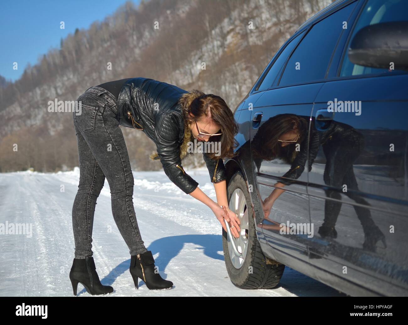 Winter car breakdown - young fashion woman trying to fix the car Stock ...