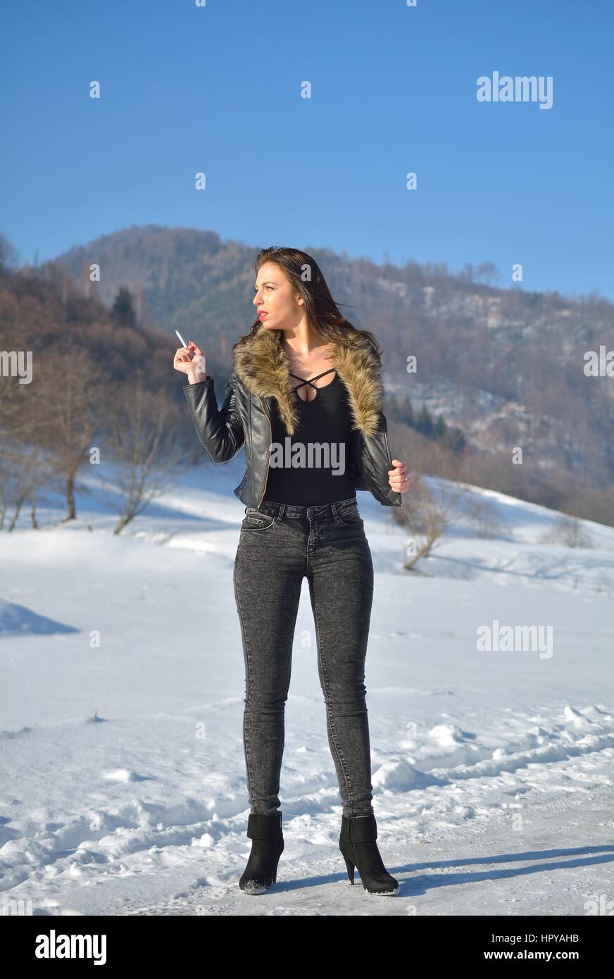 Young woman smoking outdoor in winter Stock Photo - Alamy