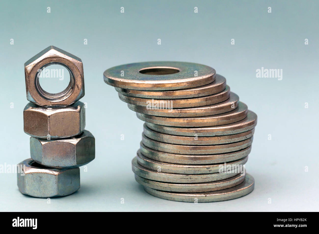 Joiner's accessories. Stacks of metal screw washers and nuts isolated ...