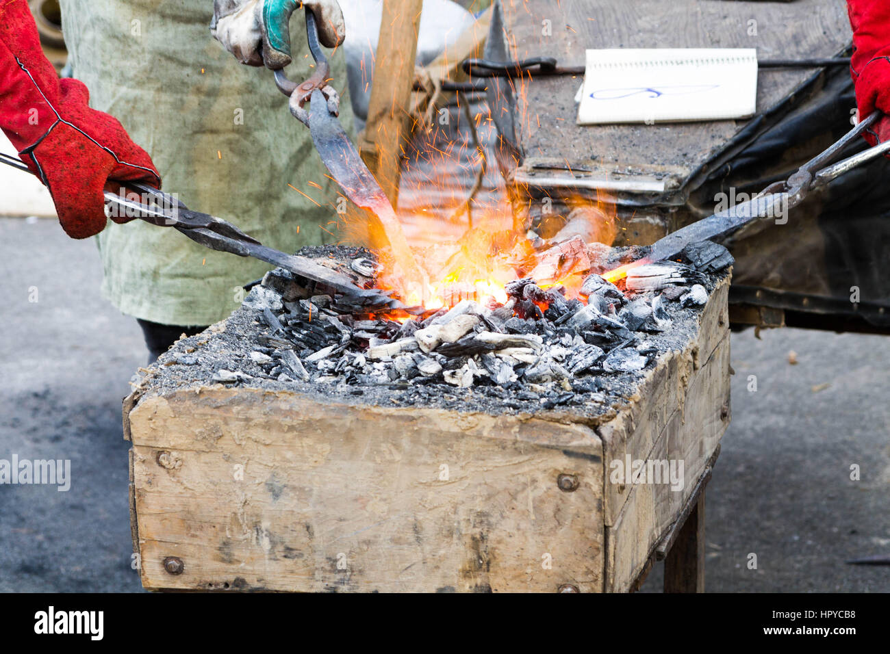 Forging hot iron. Warming iron forging. Tongs for pulling out red-hot ...