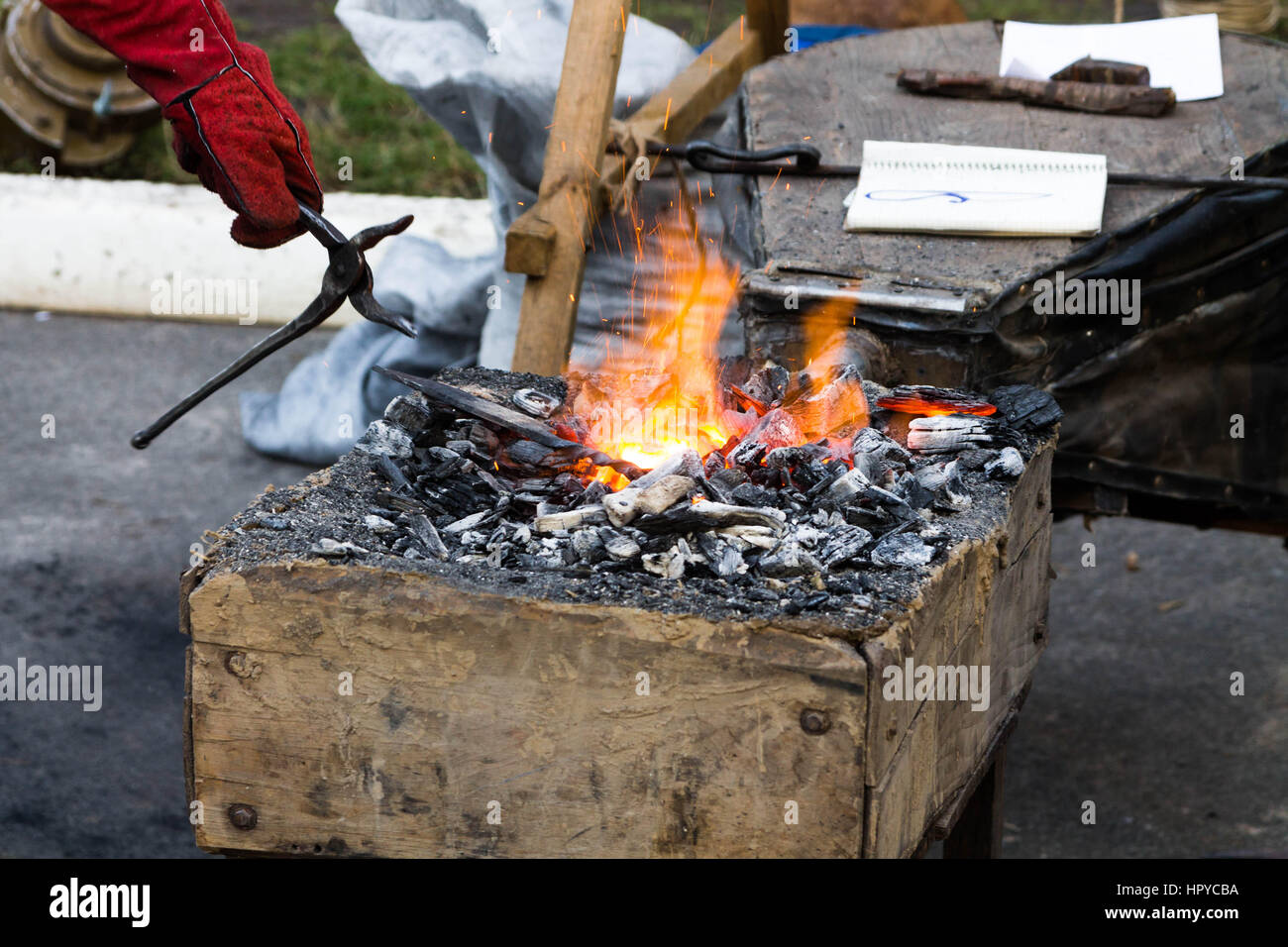Forging hot iron. Warming iron forging. Tongs for pulling out red-hot ...