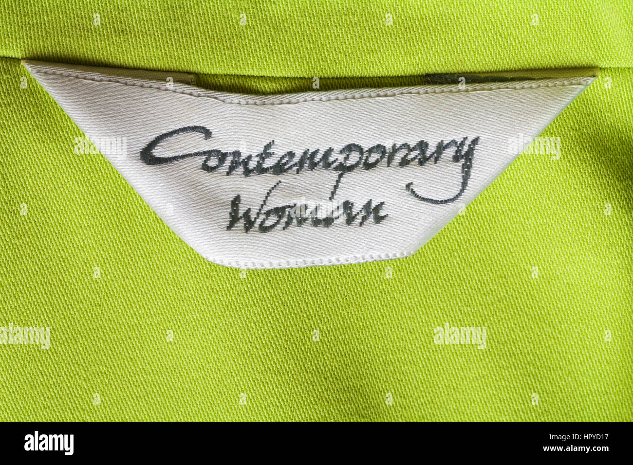Contemporary Woman label in woman's green jacket close up Stock Photo ...