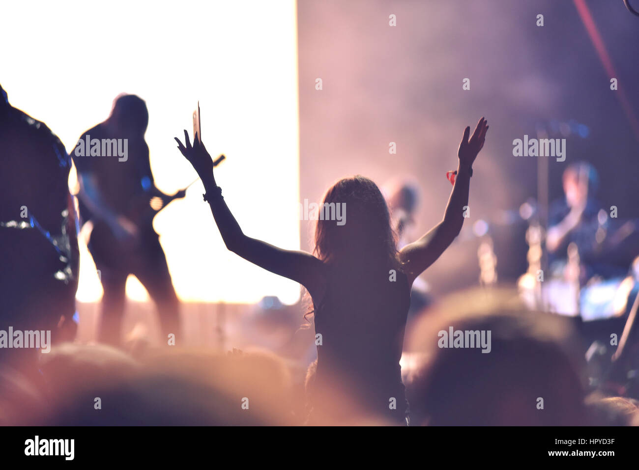Crowd at a music concert, audience raising hands up Stock Photo - Alamy
