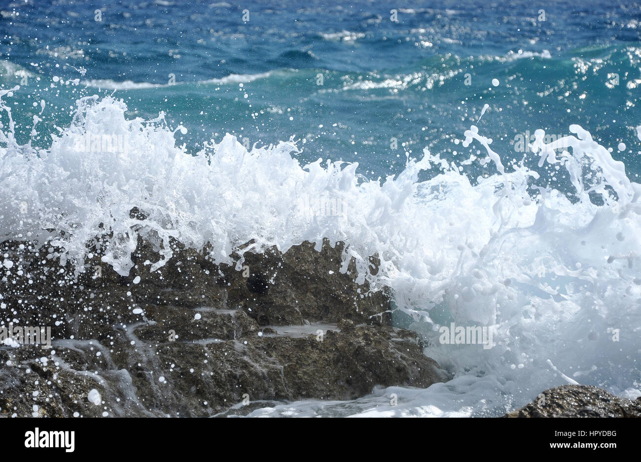 Ocean wave splashing the rocky coast Stock Photo - Alamy