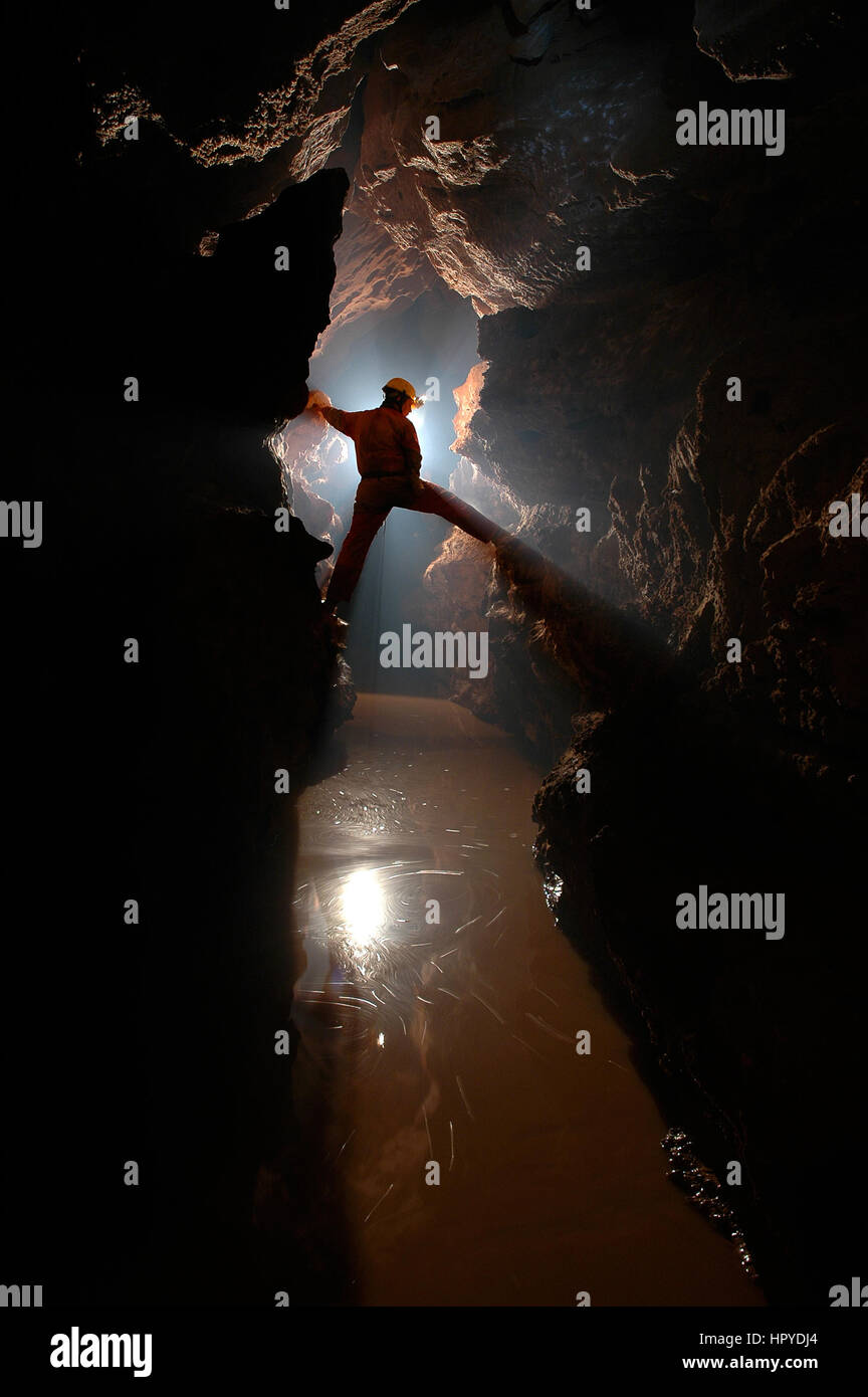 Man exploring a cave Stock Photo - Alamy