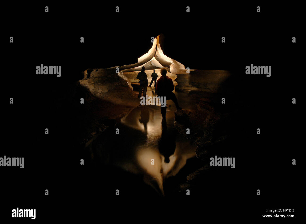 Spelunkers exploring a cave Stock Photo - Alamy