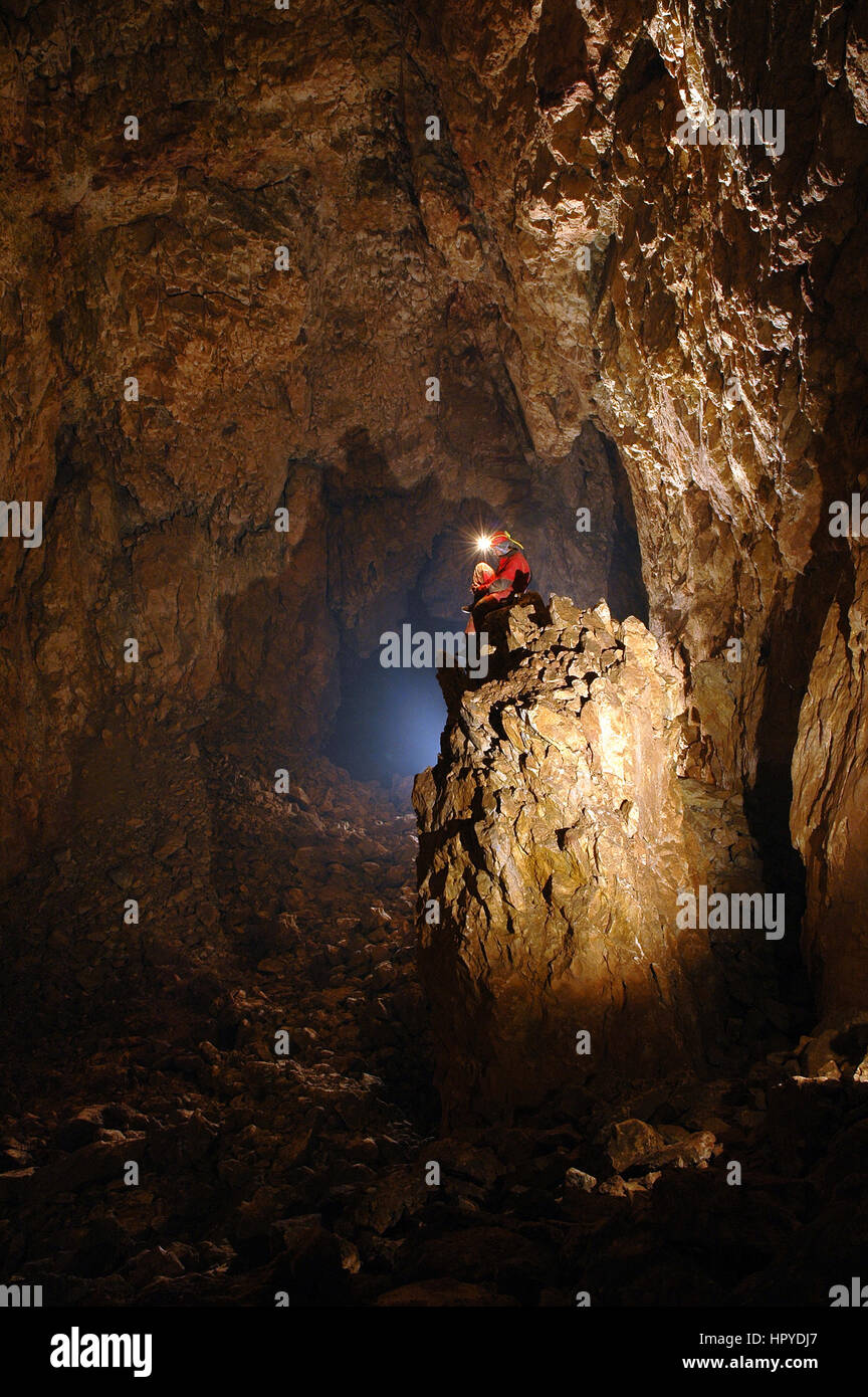 Man exploring a cave Stock Photo - Alamy