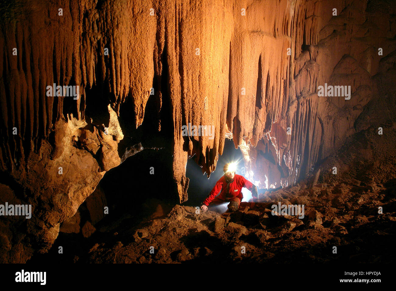Woman exploring a cave Stock Photo - Alamy