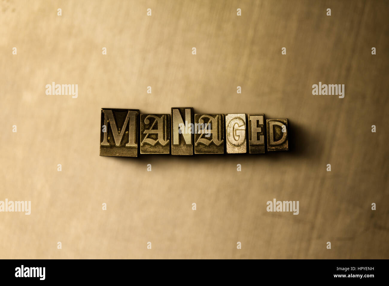 MANAGED - close-up of grungy vintage typeset word on metal backdrop ...