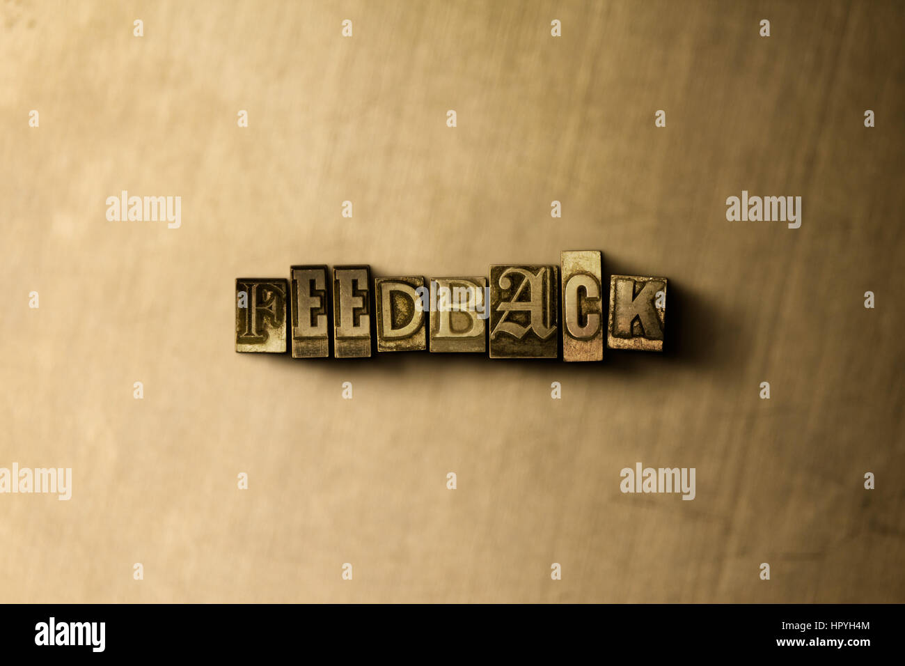 FEEDBACK - close-up of grungy vintage typeset word on metal backdrop ...