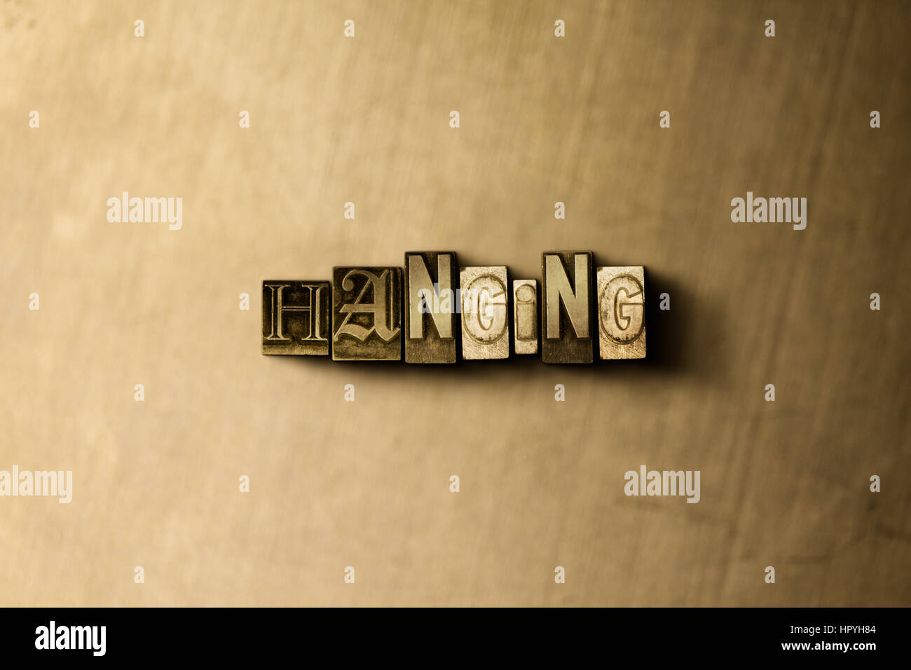 HANGING - close-up of grungy vintage typeset word on metal backdrop ...