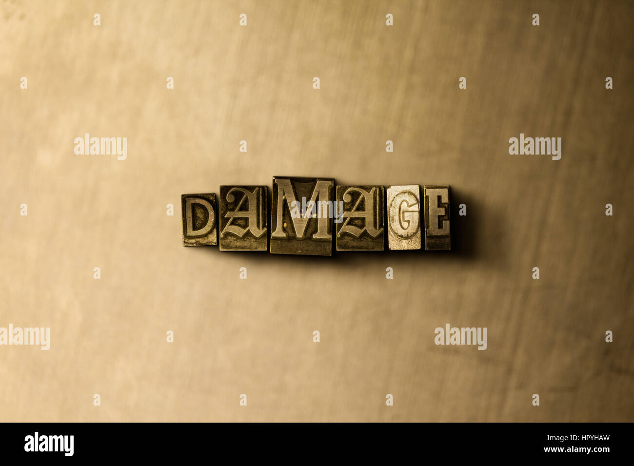 DAMAGE - close-up of grungy vintage typeset word on metal backdrop ...