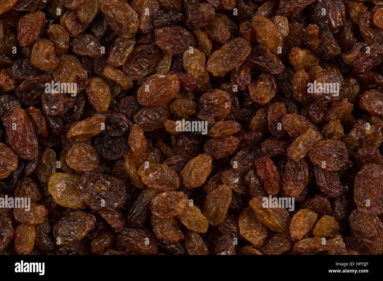 Sweet dry raisins close up shot for background Stock Photo - Alamy