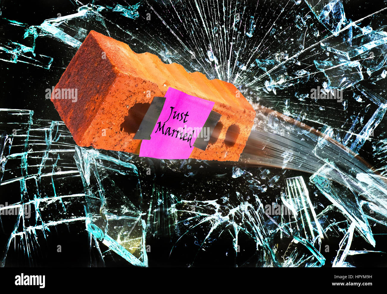 Just married with orange brick flying through glass window Stock Photo ...