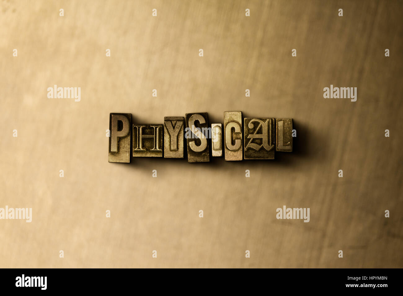 PHYSICAL - close-up of grungy vintage typeset word on metal backdrop ...