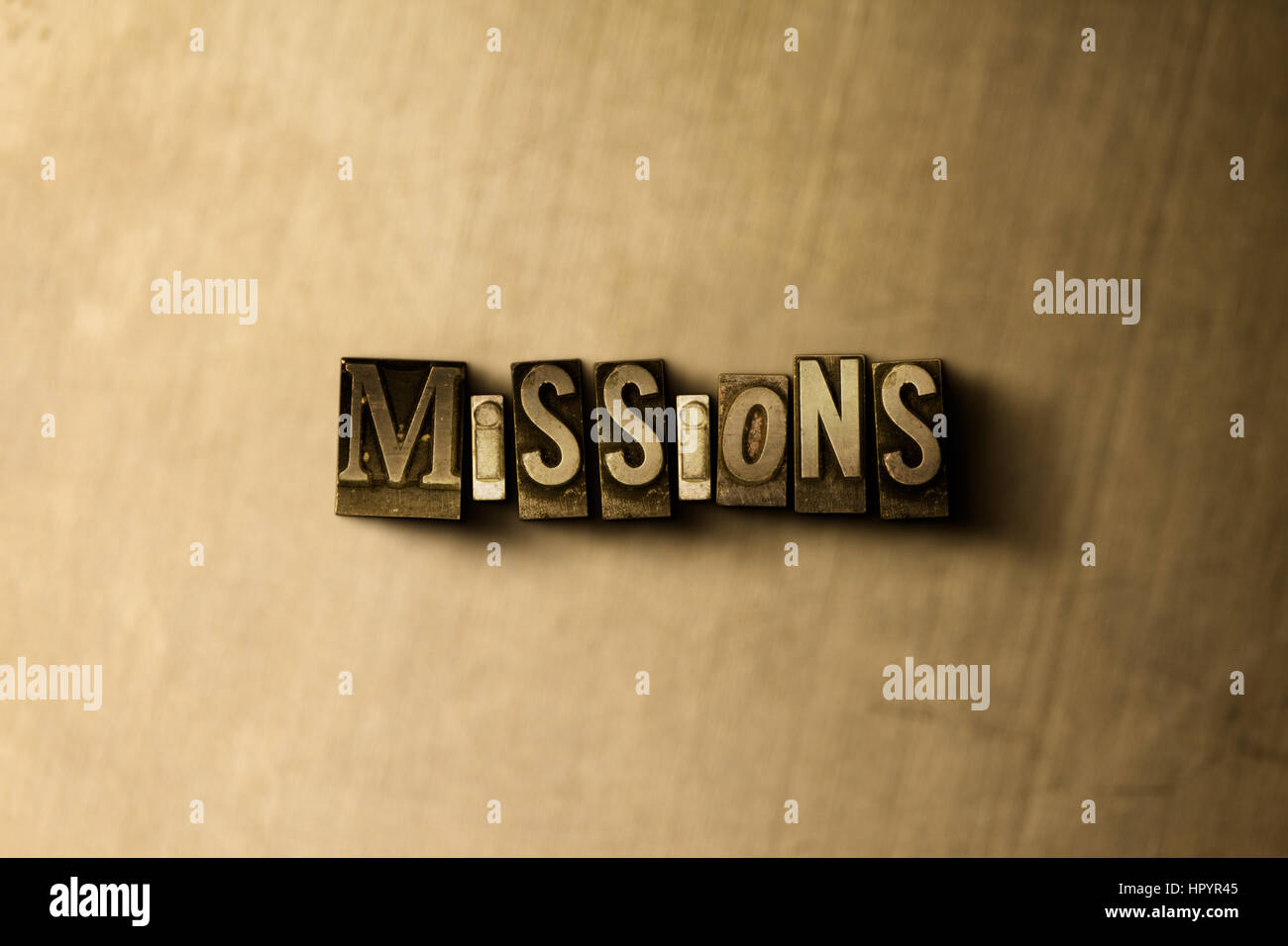 MISSIONS - close-up of grungy vintage typeset word on metal backdrop ...