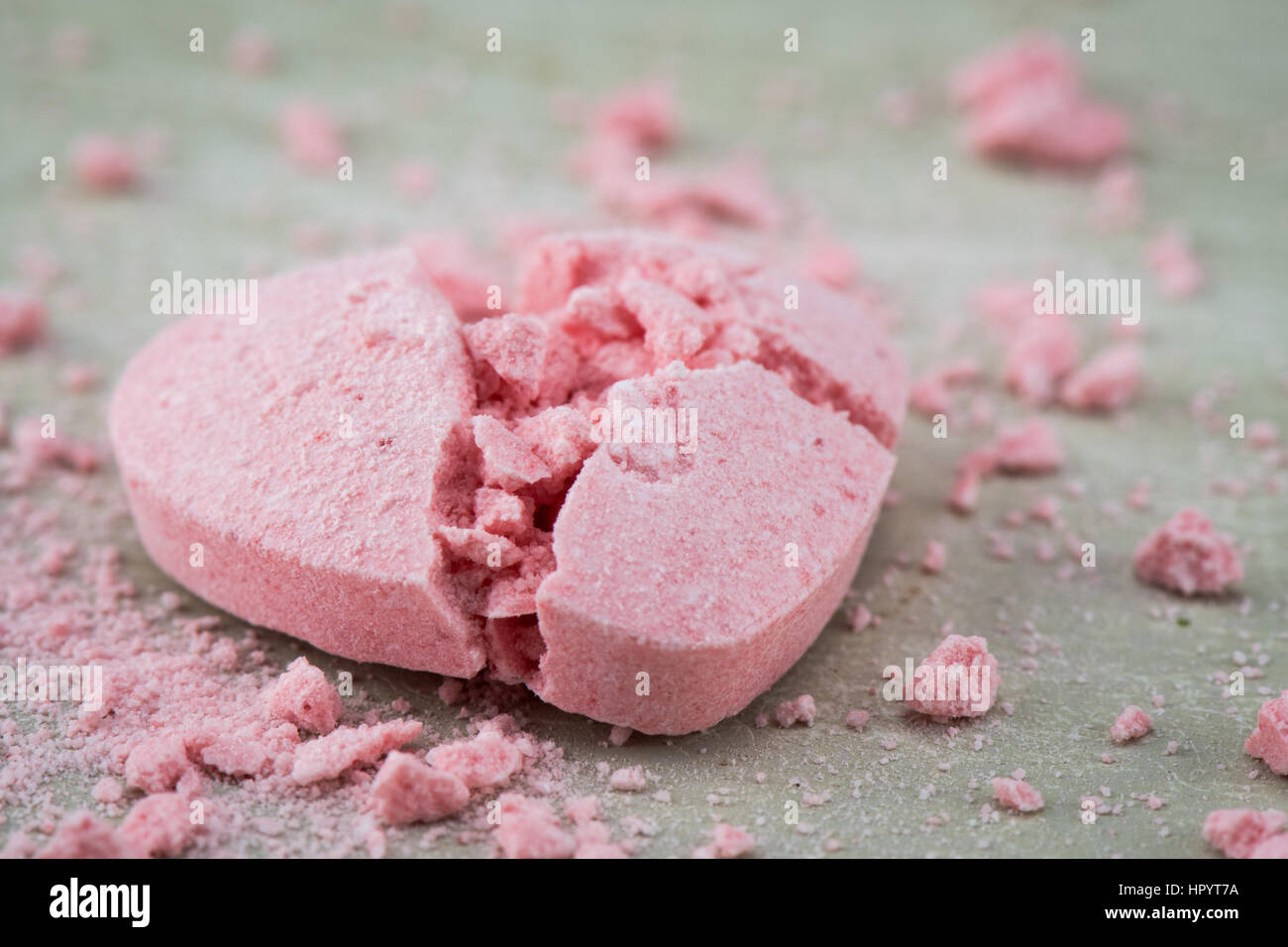 Broken Candy Heart with Crushed Candy Bits Strewn Around Stock Photo ...