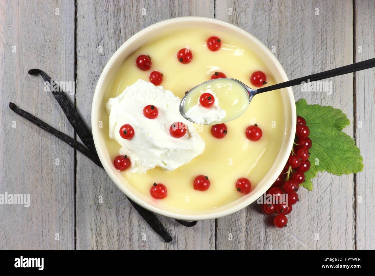 traditional Dutch custard served with red currants on wooden background ...