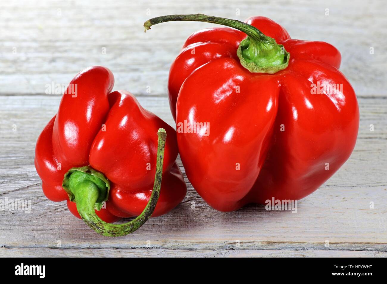 red habaneros on wooden background Stock Photo - Alamy