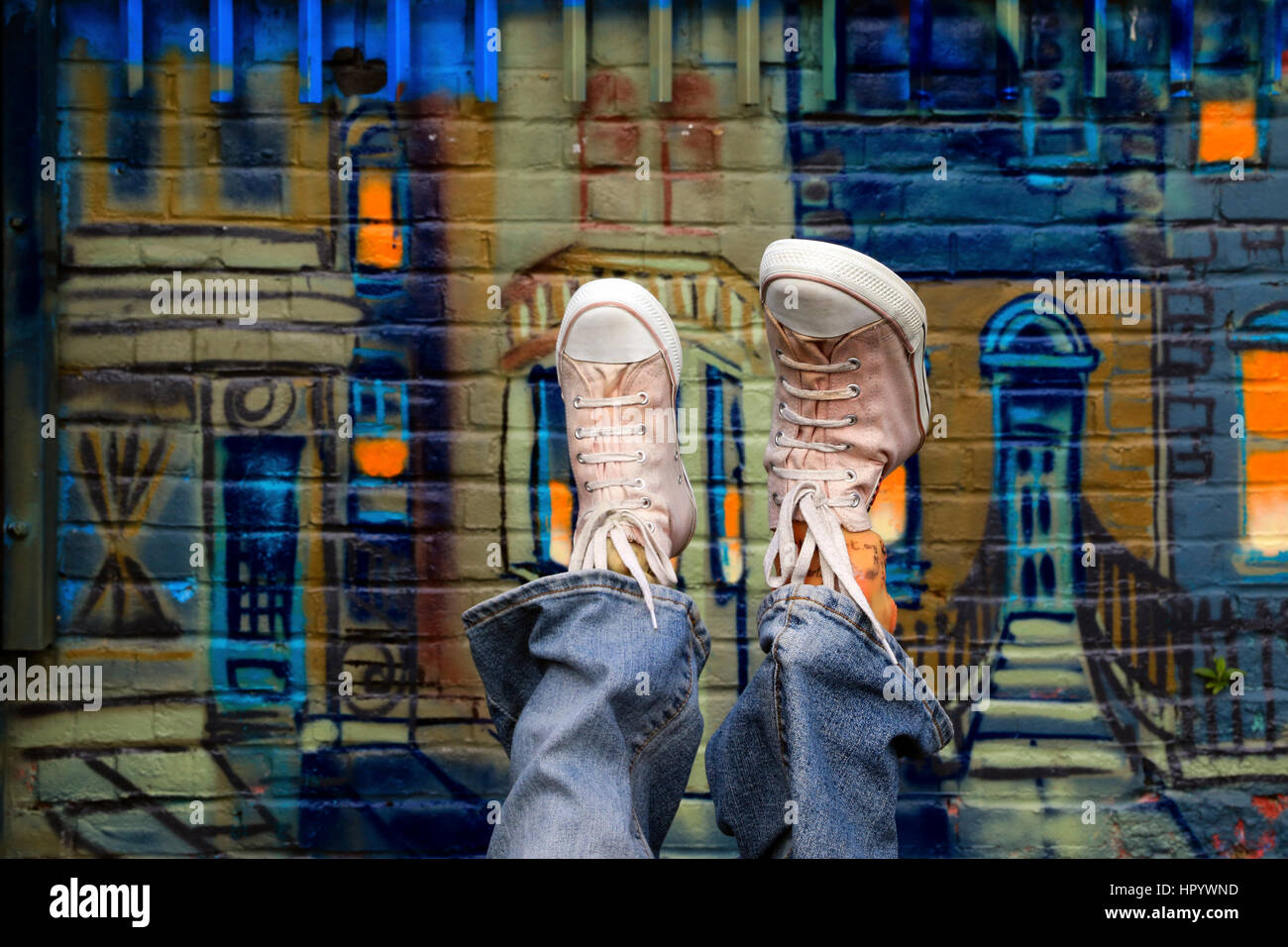 Pair of feet against graffiti background in Nomadic Community Gardens ...