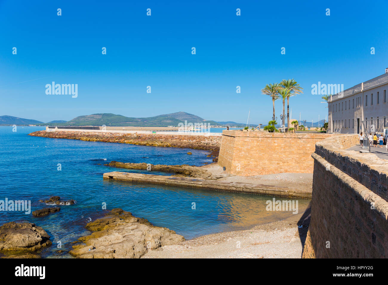 The city walls along the promenade and the harbour of Alghero, Sassari ...