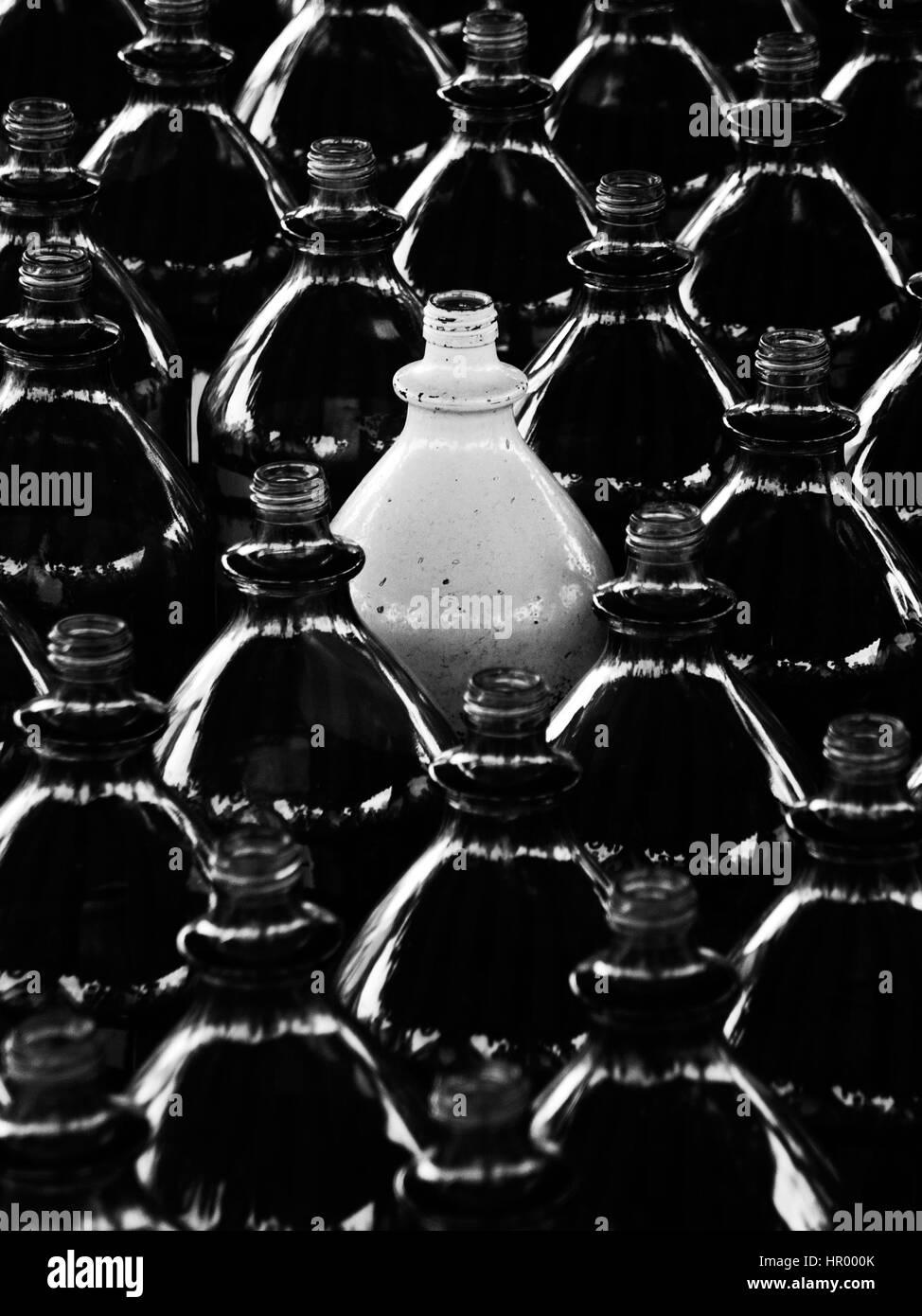 one white bottle among many transparent ones Stock Photo - Alamy