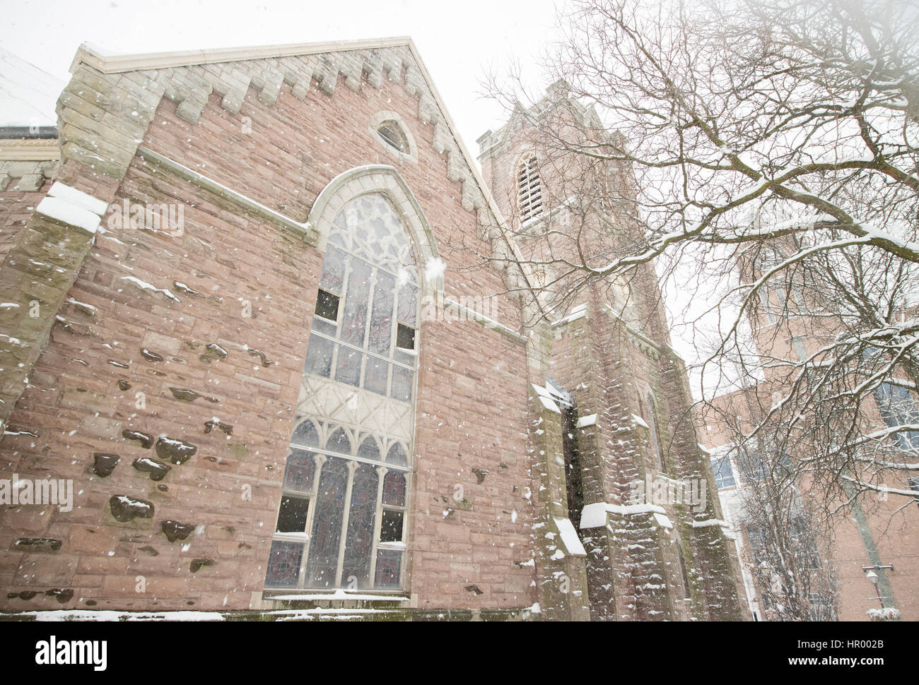 Church facade during snowfall in winter season Stock Photo - Alamy