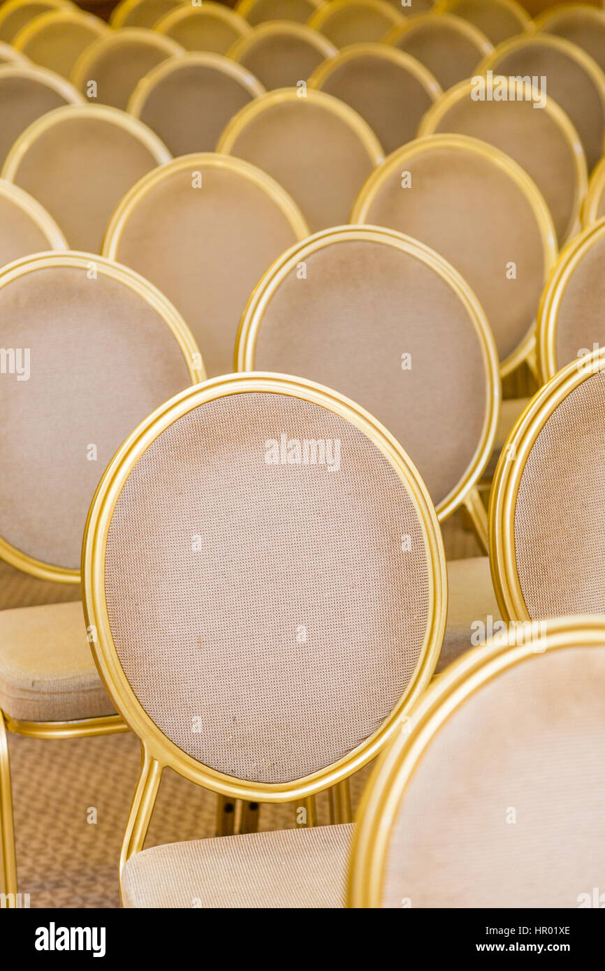 rank of empty chairs in vintage style with round seat back in ...