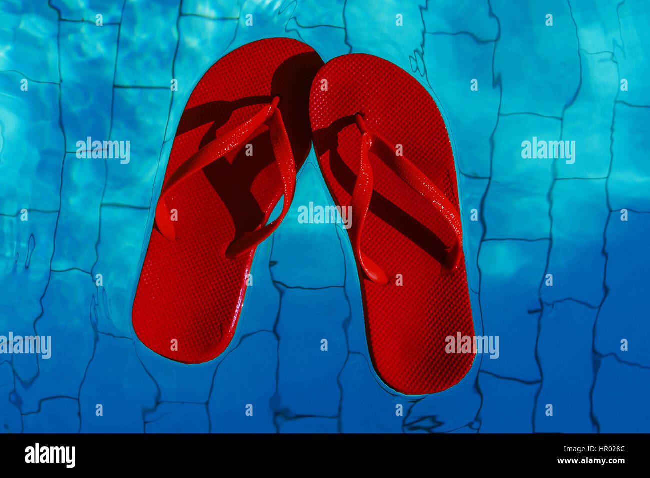red flip-flops floating in a swimming pool, a top view Stock Photo - Alamy