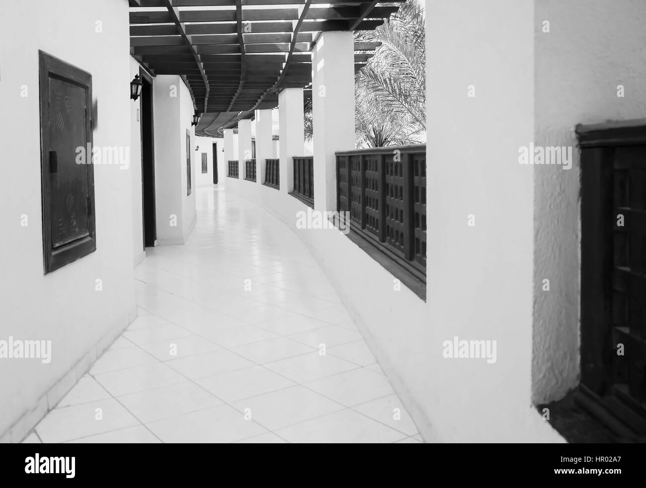 long gallery corridor with columns in perspective in black and white ...