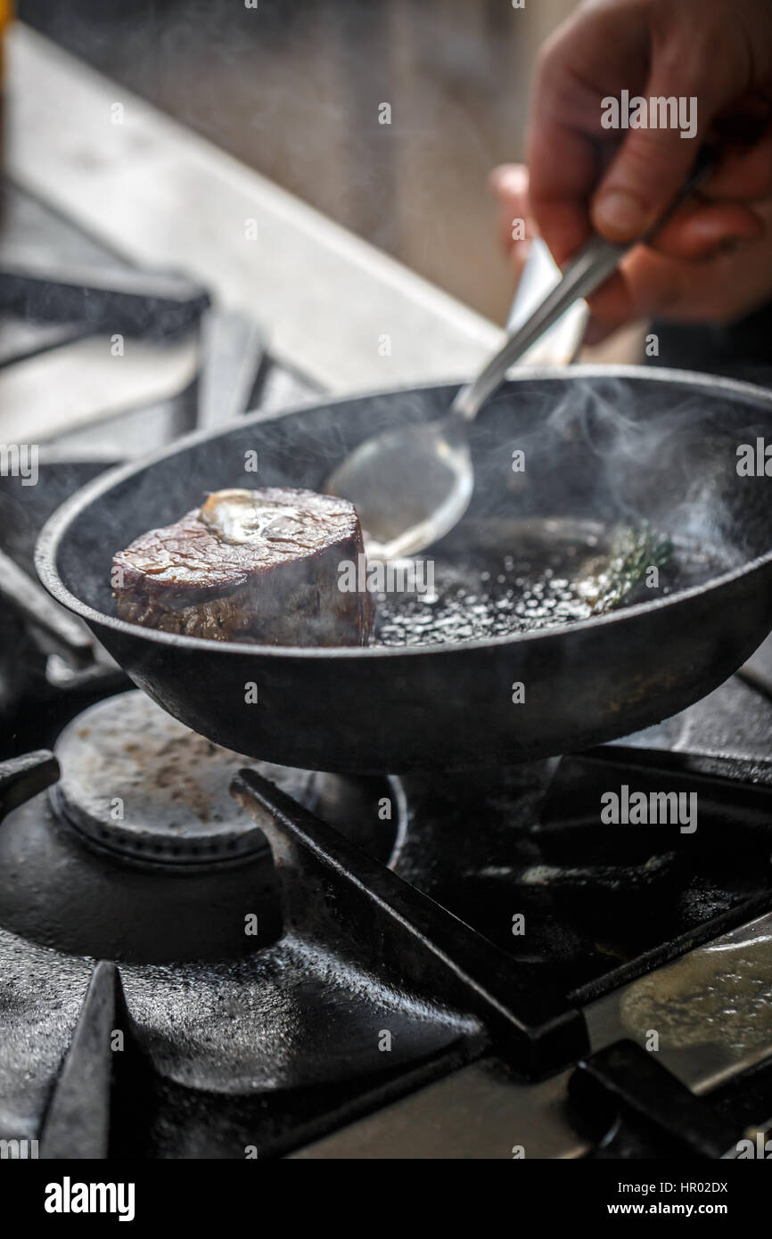 Beef steak fried in pan in restaurant kitchen Stock Photo - Alamy