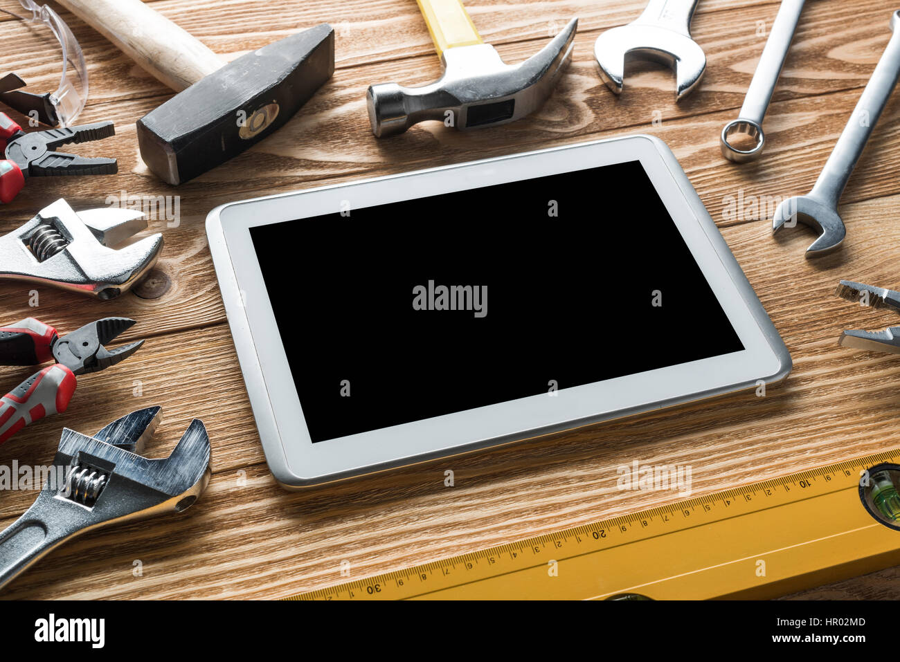 Variety of tools of builder and tablet pc on wooden texture table Stock ...