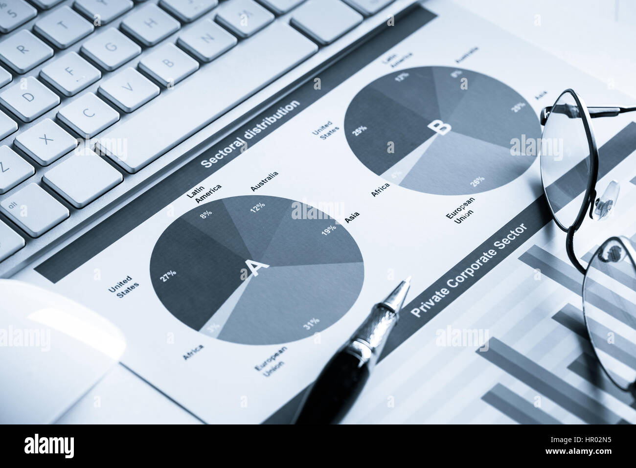 Business workplace with keyboard mouse and papers with graphs and ...