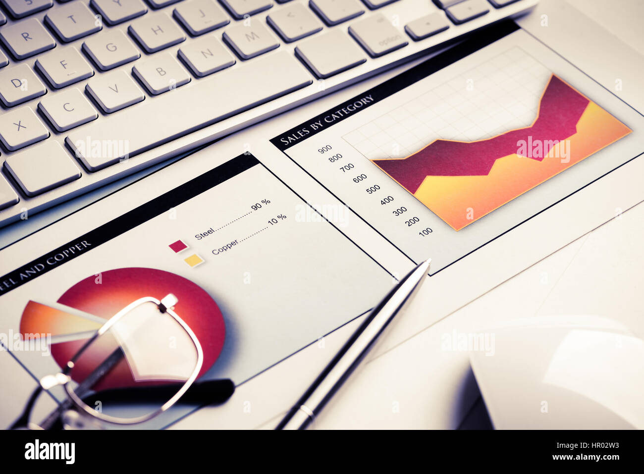 Business workplace with keyboard mouse and papers with graphs and ...