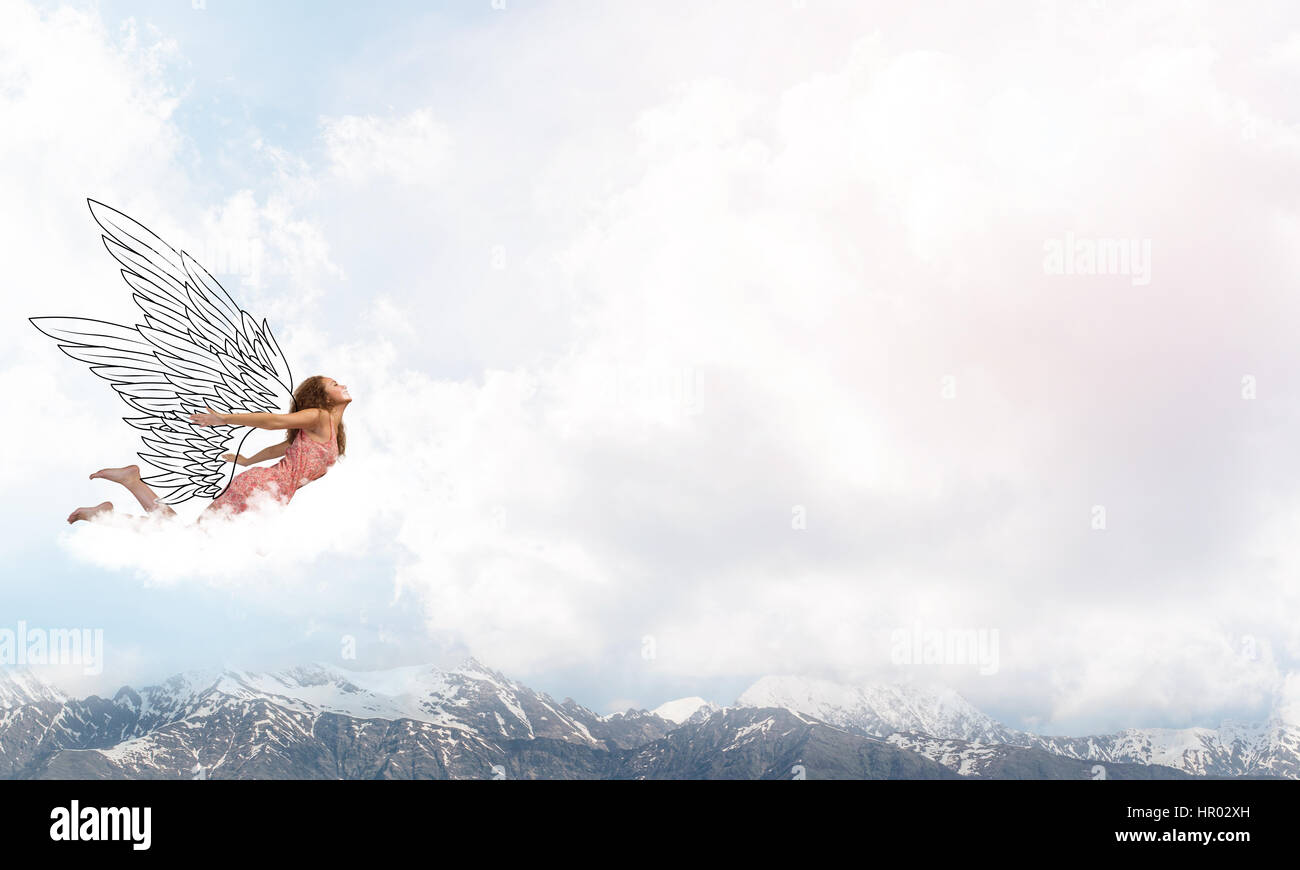 Young woman flying high in blue sky Stock Photo - Alamy