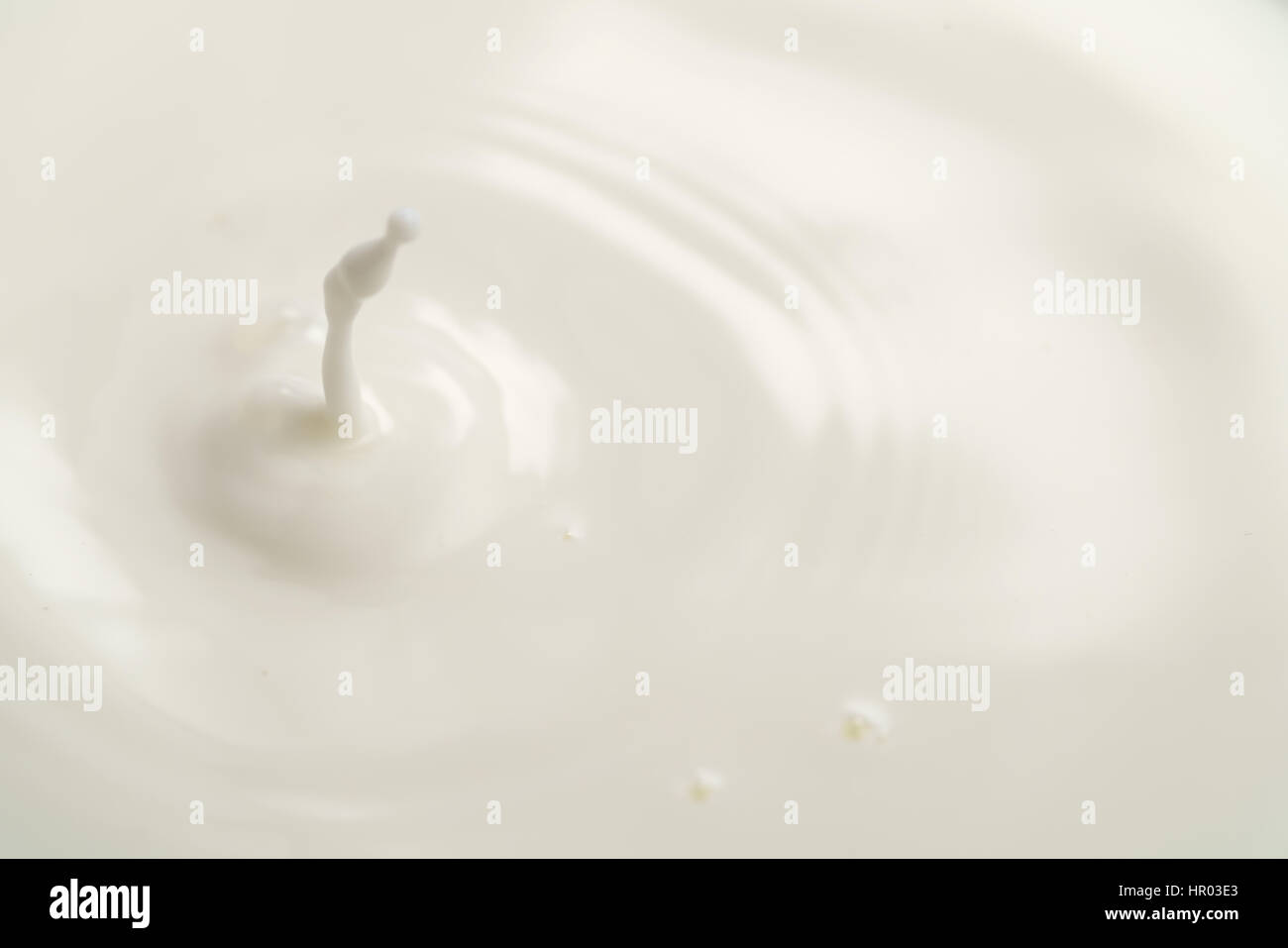 pouring milk into bowl from above, closeup photo Stock Photo - Alamy