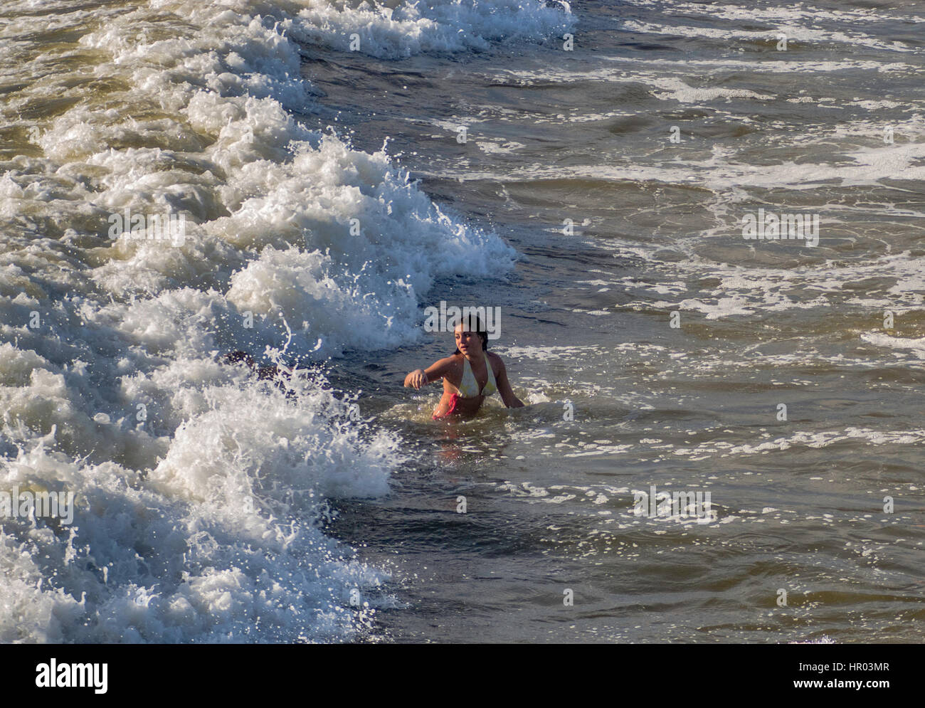 Young woman swimming at Pacific Ocean beach in Santa Monica, California ...