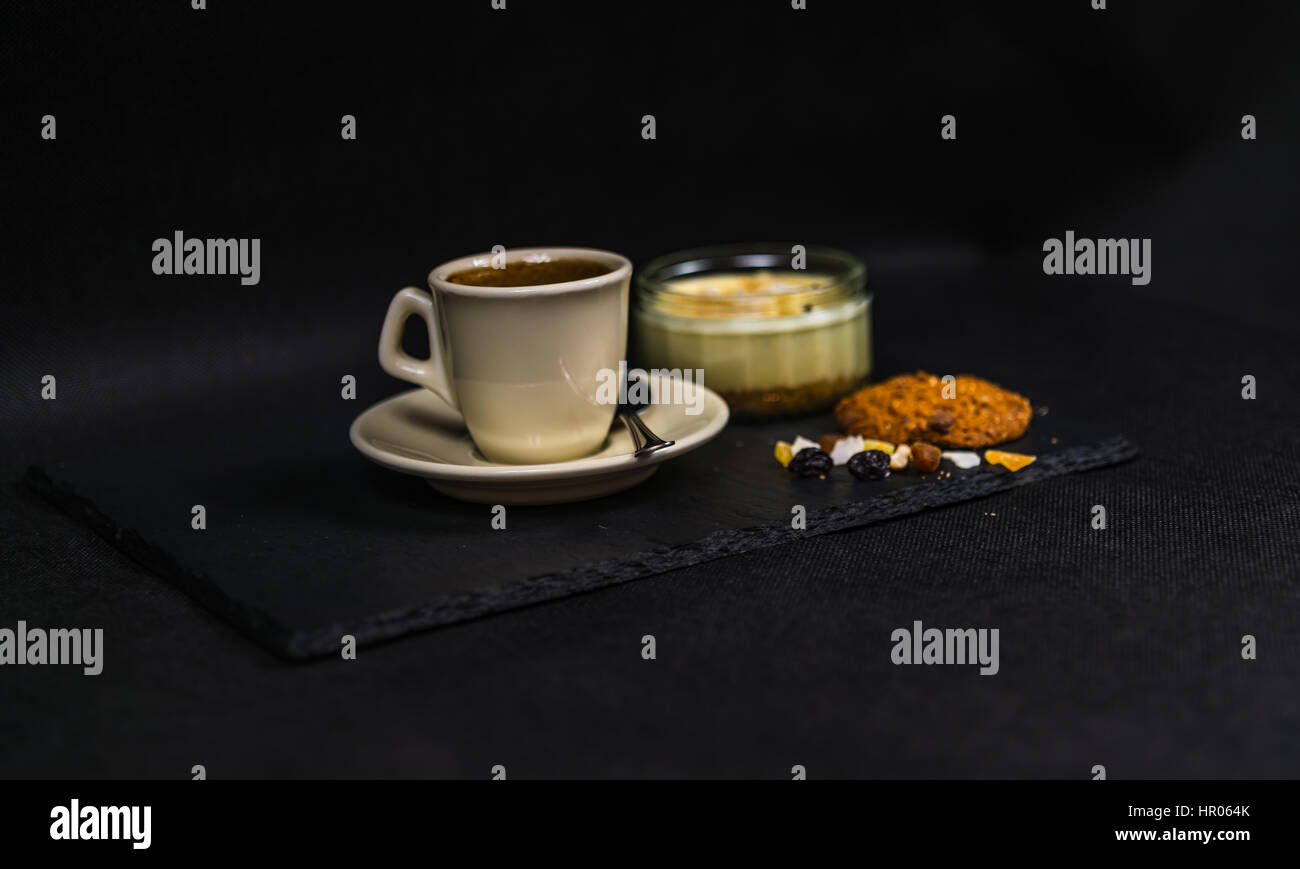 left side view on an aromatic black coffee in a cup of creamy, sweet ...