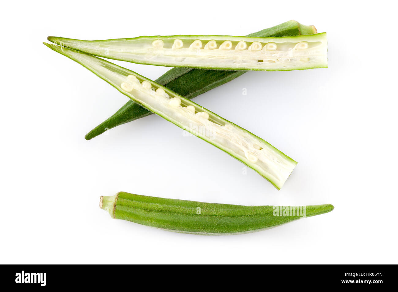 Okra pods, whole and sectioned on white background Stock Photo - Alamy