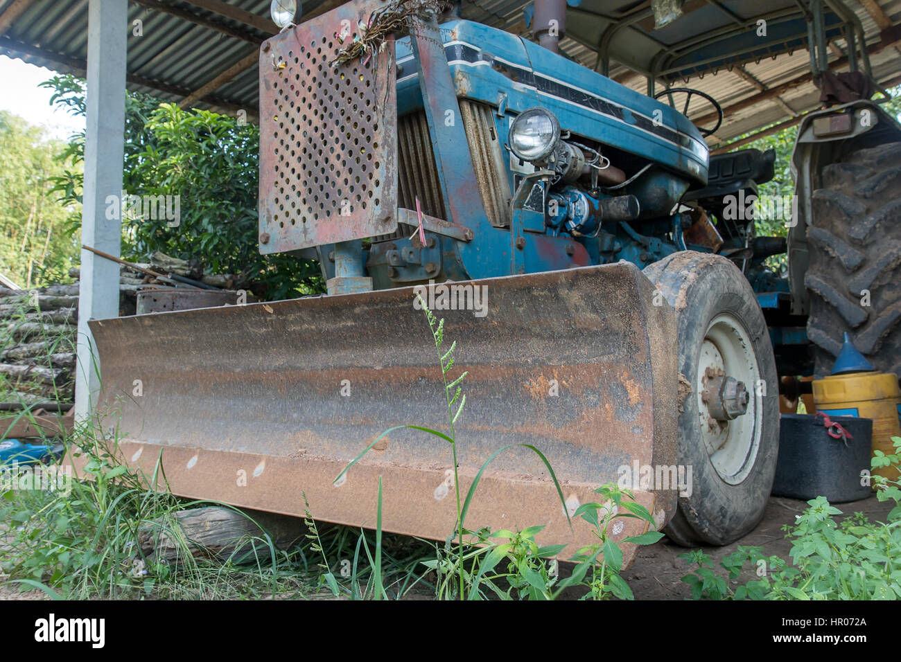 Dirty old tractor parked under a shed on the farm Stock Photo - Alamy