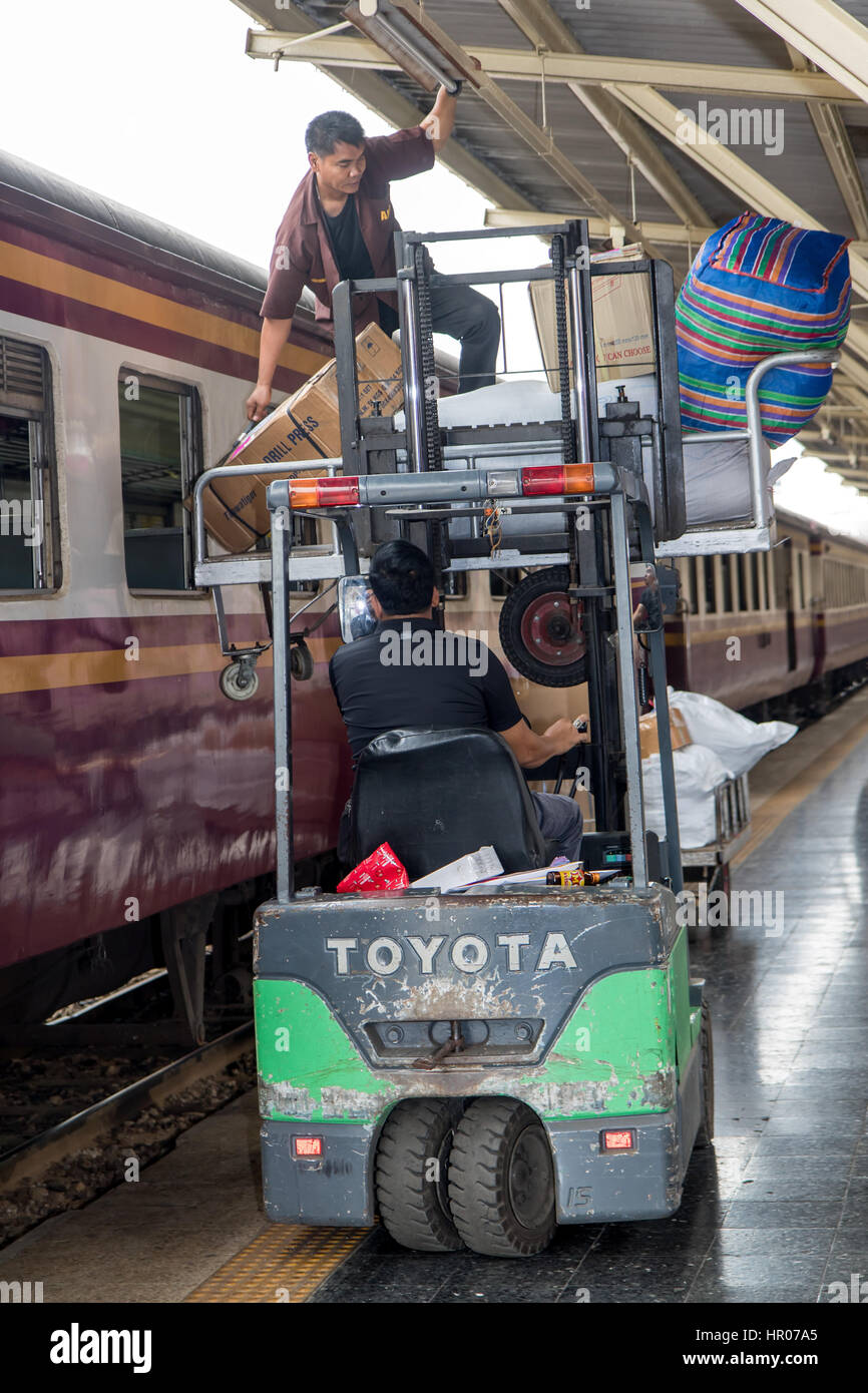 Men loaded packages into the train through the window of the car ...