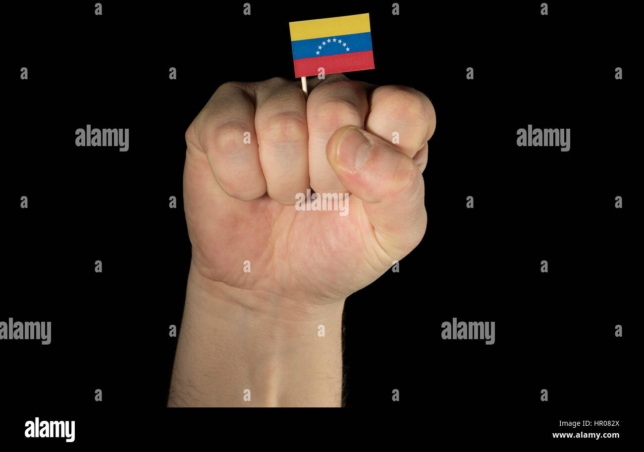 Man hand fist with Venezuelan flag isolated on black background Stock ...
