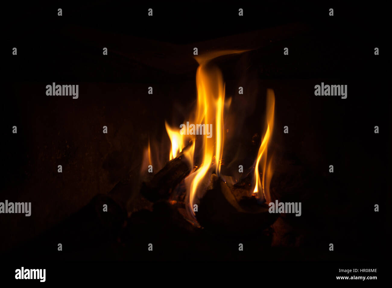 Chimney flames, fire in a chimney on dark background Stock Photo - Alamy