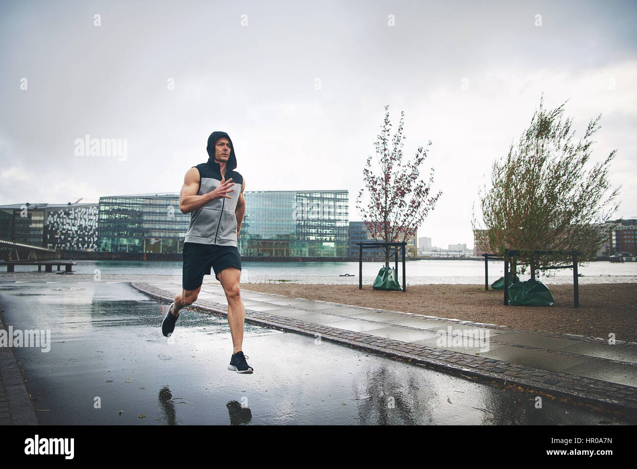 Young man running in rain hi-res stock photography and images - Alamy